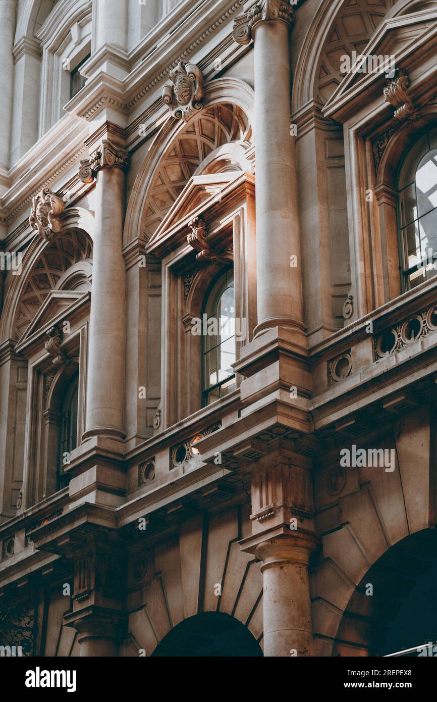 The light is hitting a window on a beautiful old building in London ...