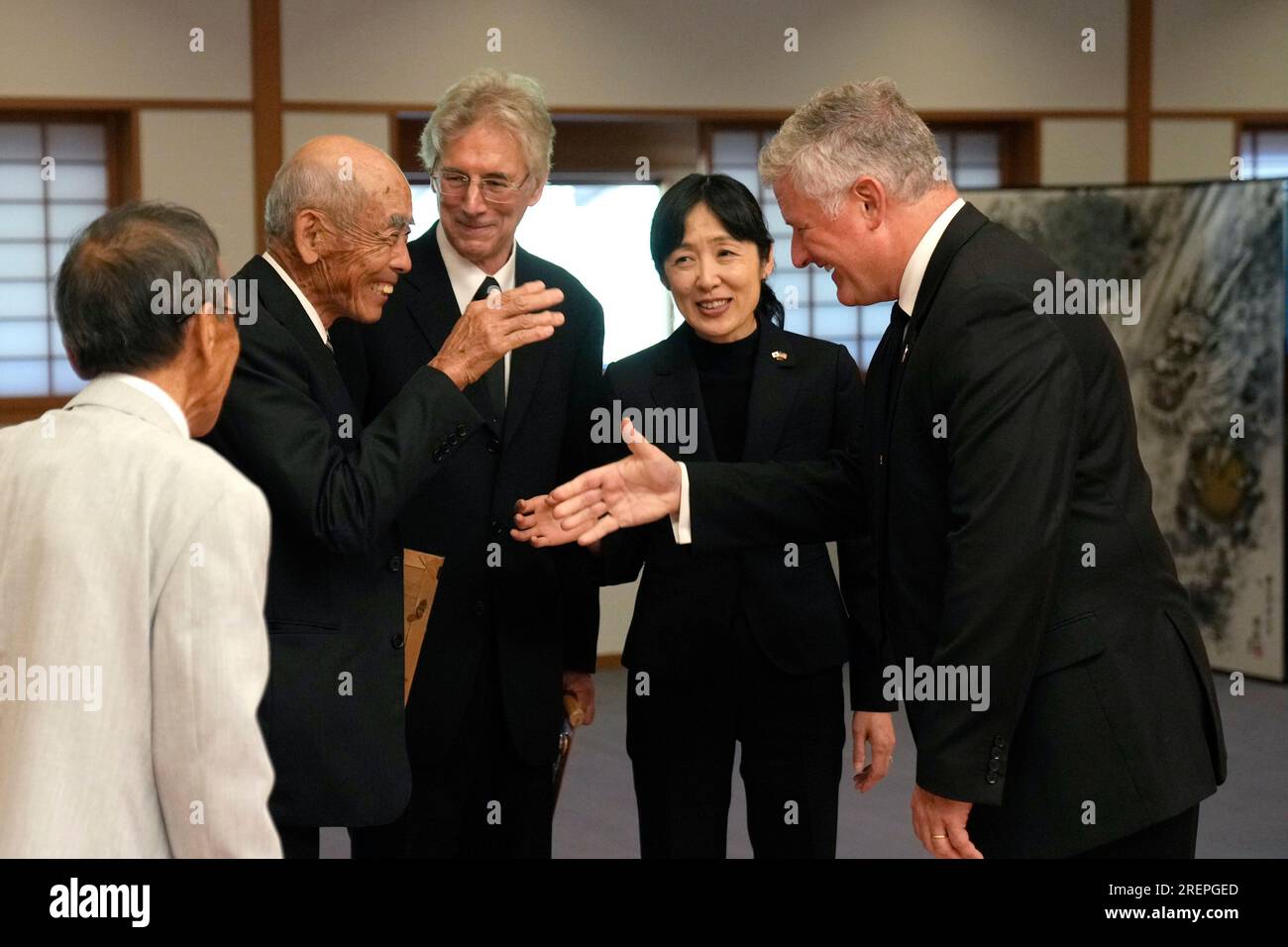 Toshihiro Mutsuda, second left, the elderly son of Japanese soldier ...