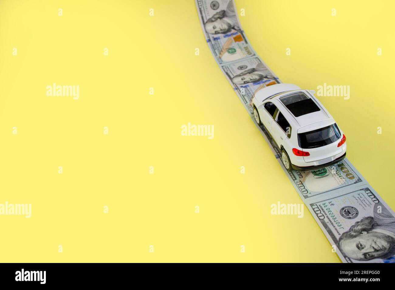 White toy car on money road on yellow background with copy space Stock ...