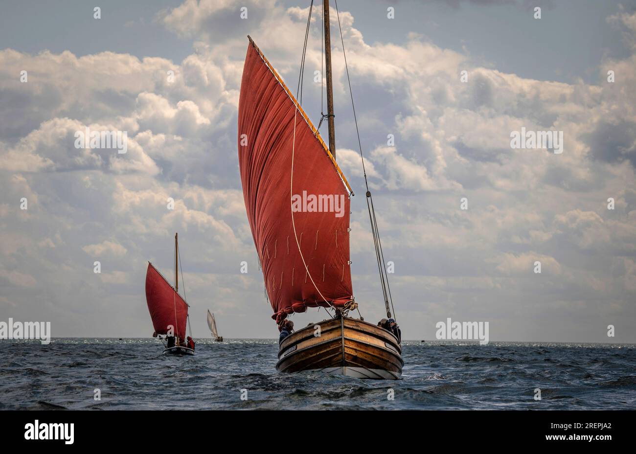 Traditional Coble fishing boats are sailed off the coast of Bridlington ...