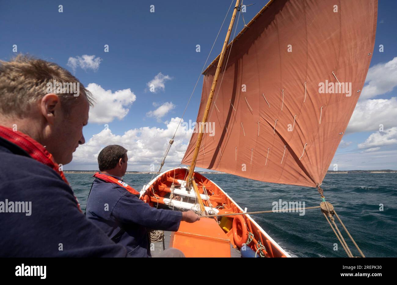 A traditional Coble fishing boat is sailed off the coast of Bridlington ...