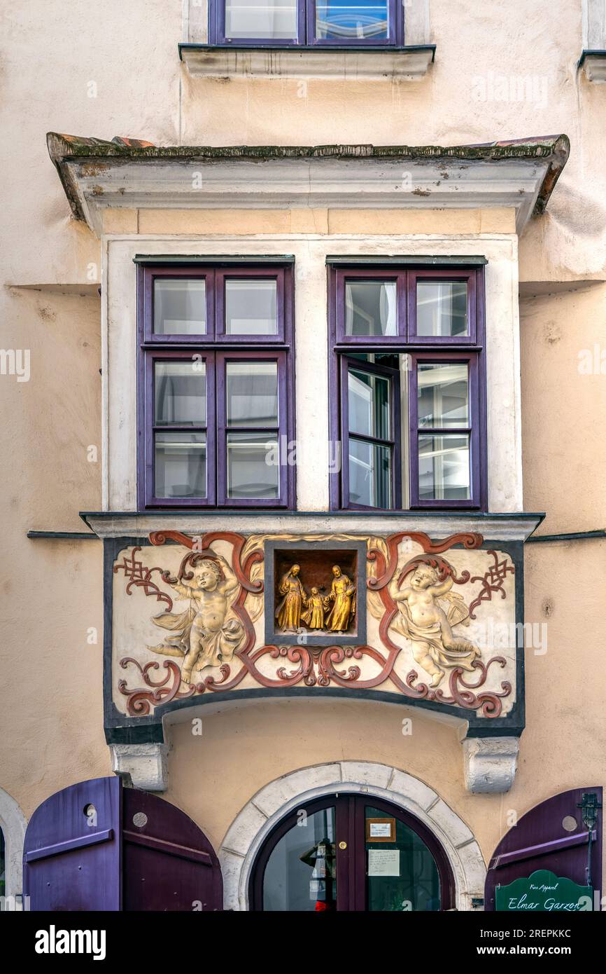 Golden statues of Mary, Joseph and Jesus inside a niche with cherubs ...