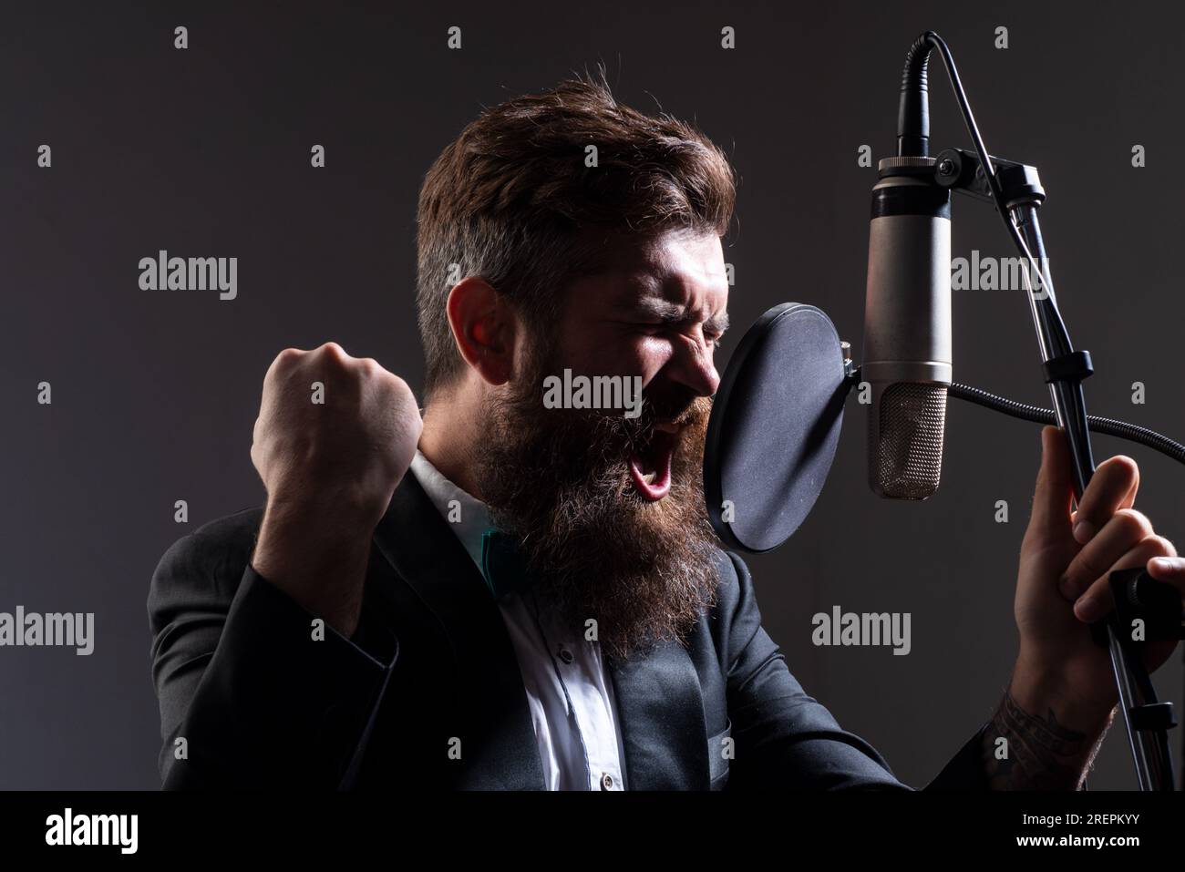 Singer gestures with hands. Singer wearing headphones is performing a ...