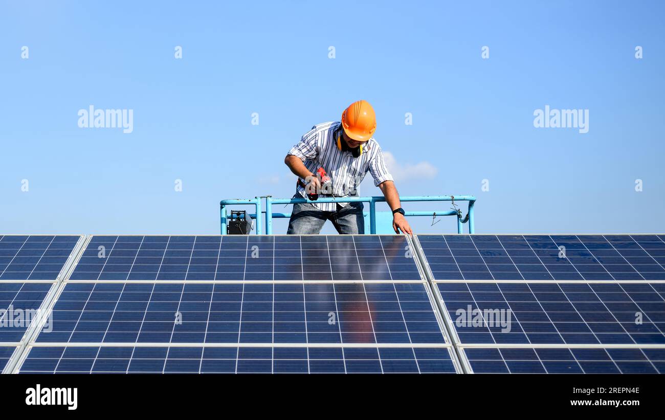 Professional technician worker installing solar panels at solar cell ...