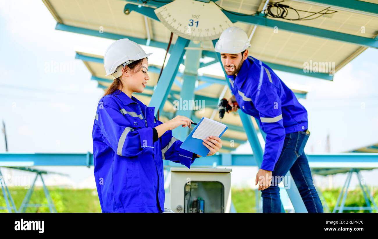 Technicians workers installing solar panels at solar cell farm Stock ...