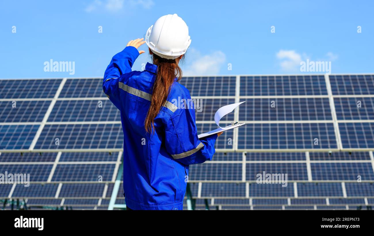 Female engineer worker with solar panels at solar farm Stock Photo - Alamy