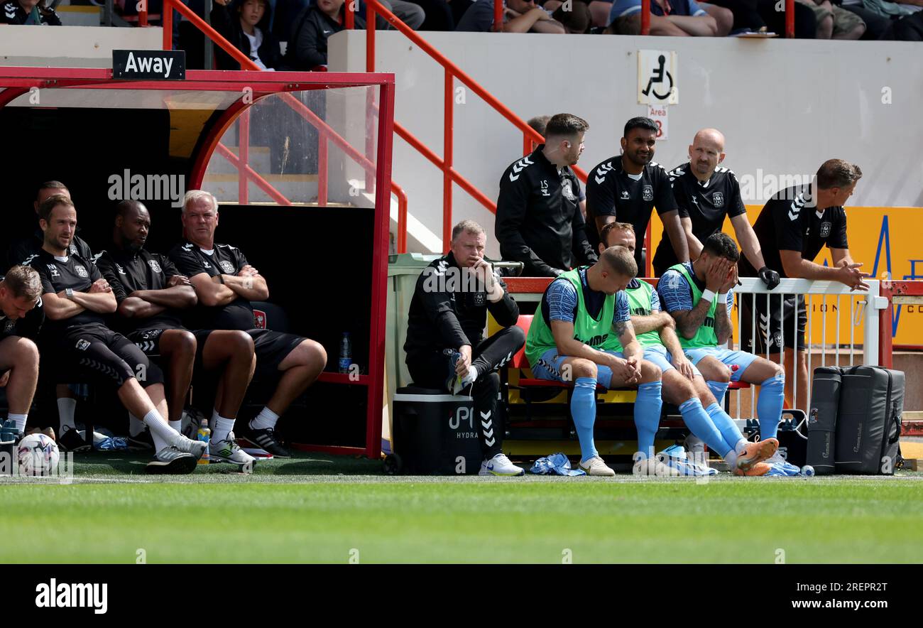 Coventry City manager Mark Robins (centre) sitting on the bench during ...