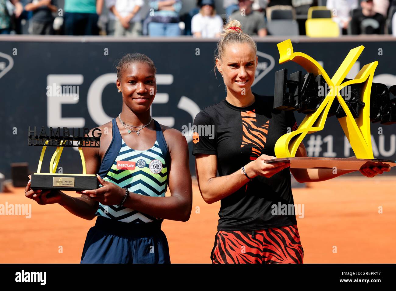 Netherlands' Arantxa Rus, right, and Germany's Noma Noha Akugue, hold their trophies after the ...