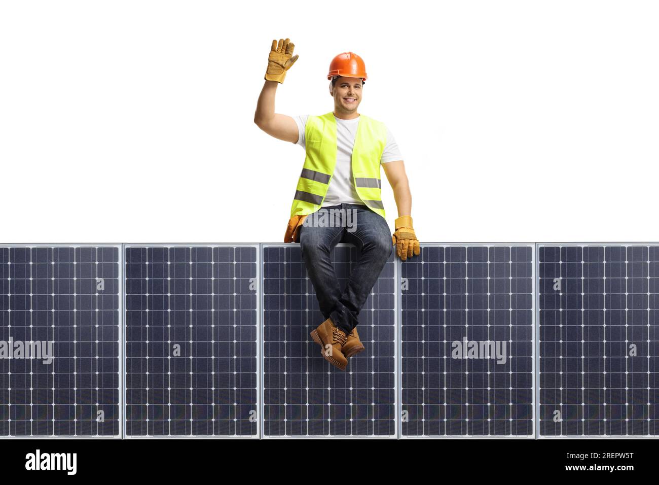 Full length portrait of a construction worker sitting on a solar panel ...