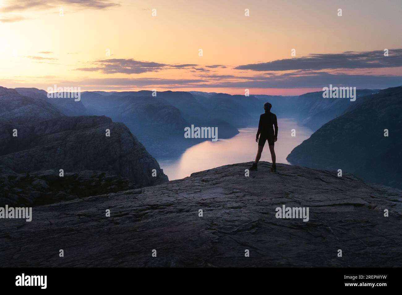 The single person standing alone on the edge of the cliff Preikestolen ...