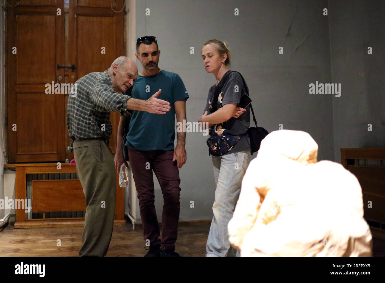 Visitors look at the wooden sculptures by the author Volodymyr Semkiv ...