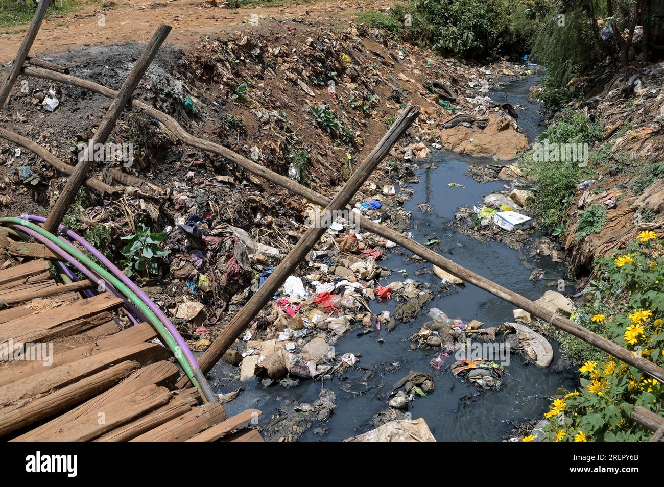 KENYA, Nairobi, Kibera slum, water hose and sewage / KENIA, Nairobi ...