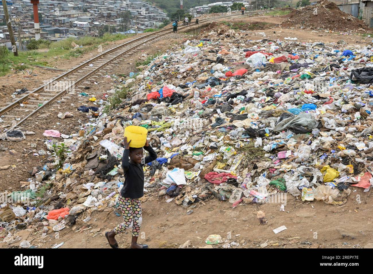 KENYA, Nairobi, Kibera slum, children at railway track, dumped garbage ...