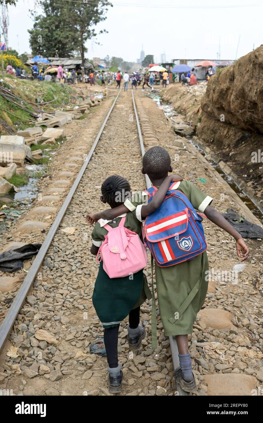 KENYA, Nairobi, Kibera slum, pupils with tornister walking from school ...