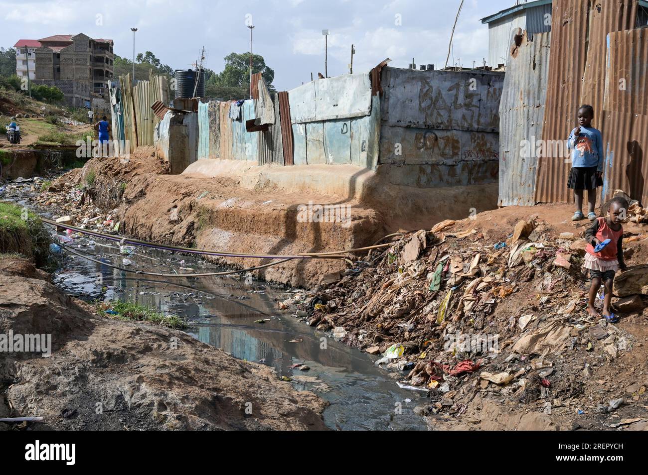 KENYA, Nairobi, Kibera slum, water hose and sewage / KENIA, Nairobi ...