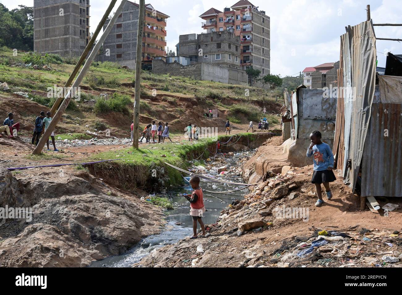 KENYA, Nairobi, Kibera slum, water hose and sewage, behind new ...