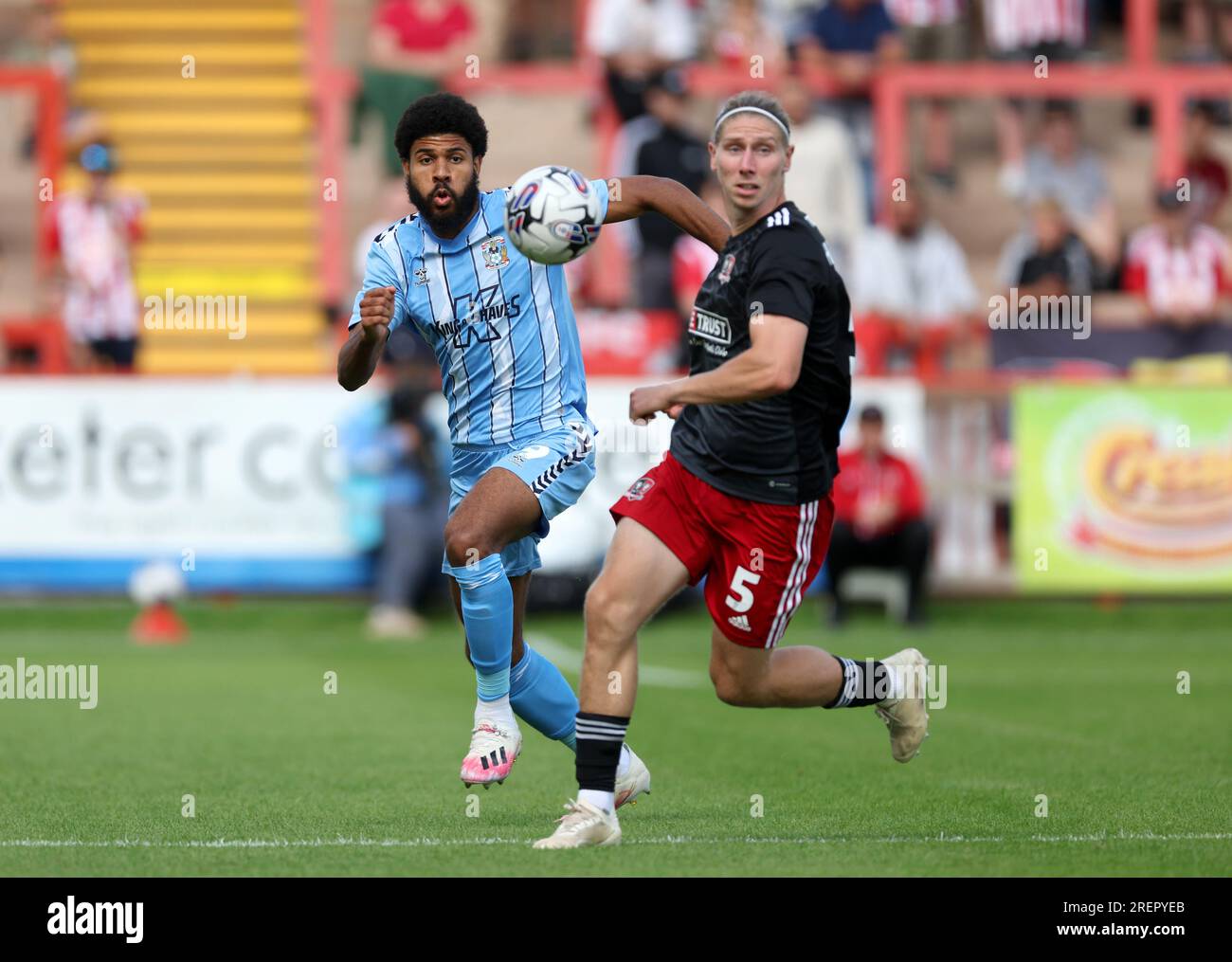 Coventry City's Ellis Simms (left) and Exeter City's Alex Hartridge ...