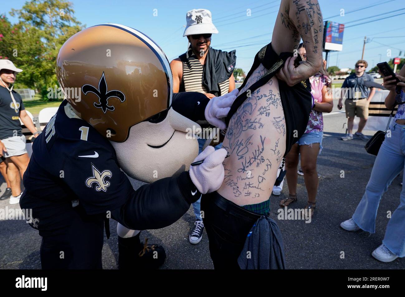 New Orleans Saints mascot "Sir Saint autographs the back of tattooed ...