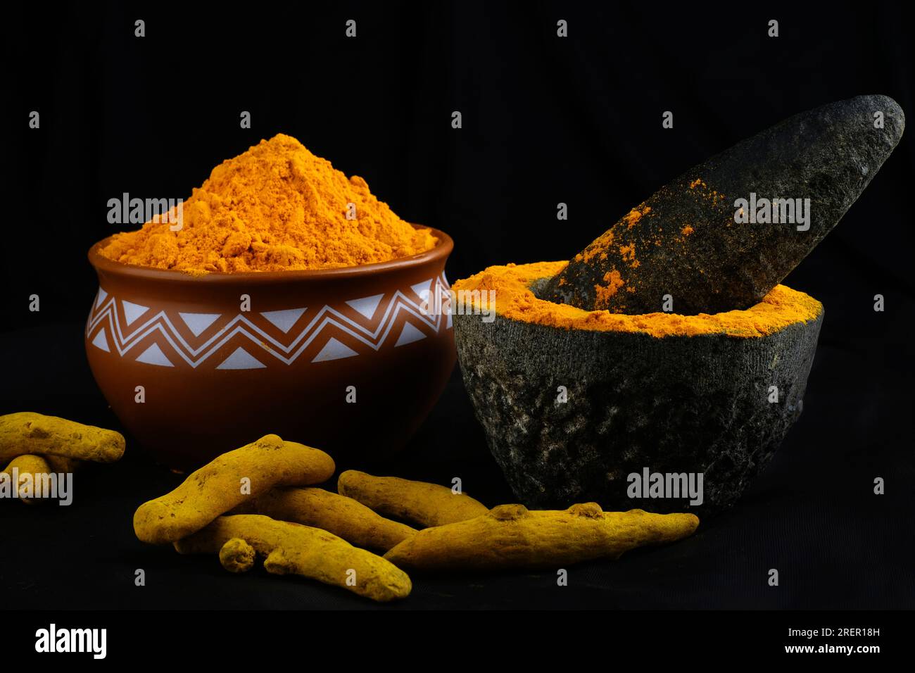 Dry turmeric powder (curcuma longa linn) stone mortar, traditional ...