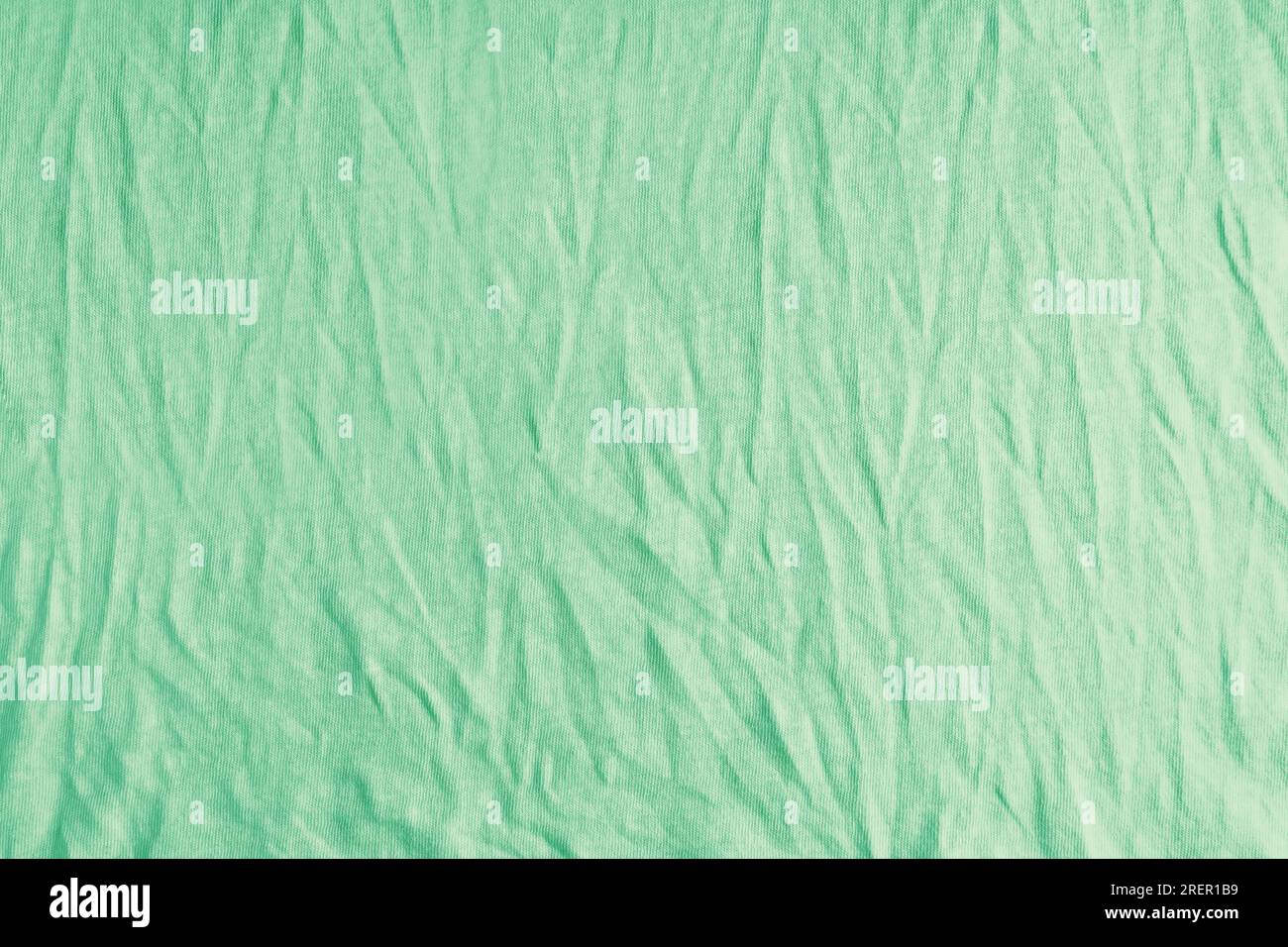 Wrinkled, crumpled green fabric texture background. Wrinkled and ...
