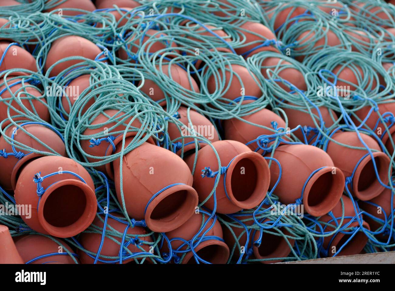 Terracotta octopus pot traps in nets. Clay pot fishery industry in ...