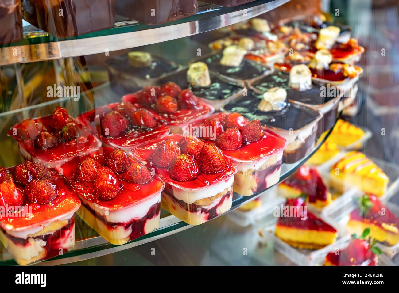 Assorted delicious fruit desserts, cakes and biscuits on shopwindow in ...