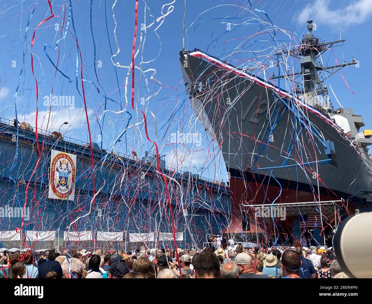 Streamers are shot in the air as a future U.S. Navy destroyer bearing ...