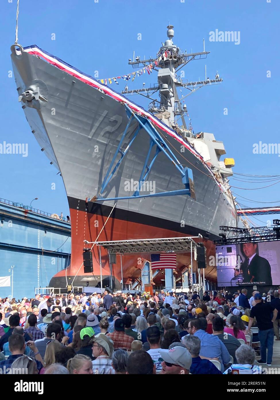 A crowd gathers to see the christening of a warship bearing the name of ...