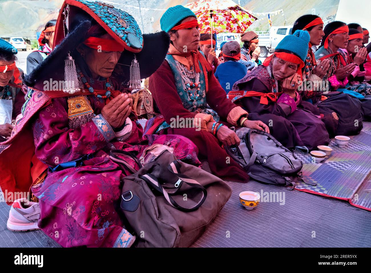 Ladakhi women in traditional clothing (perak headdress) at a high lama ...