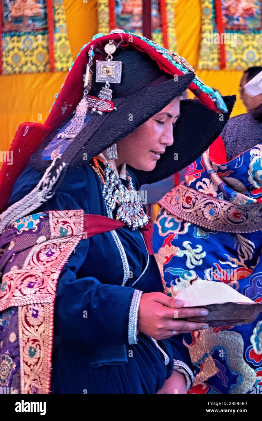 Ladakhi woman in traditional clothing (perak headdress) at a high lama ...
