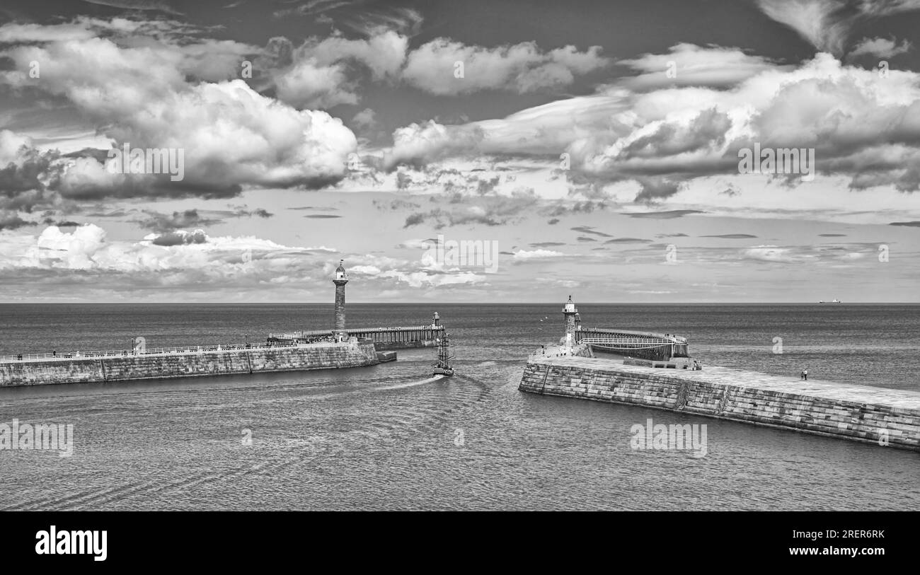 Whitby harbour entrance. Two lighthouses stand at the end of each pier ...