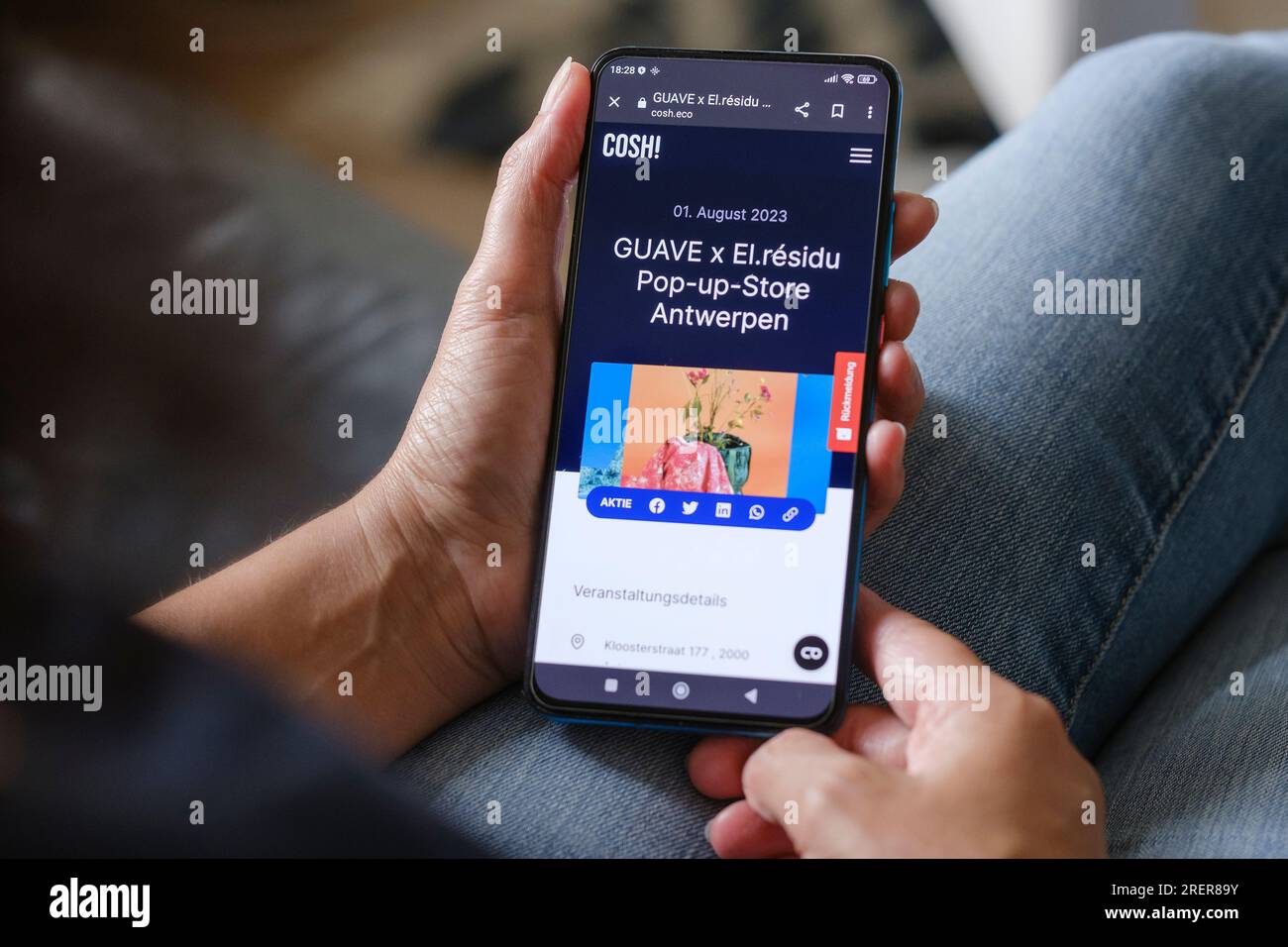 Woman holding smartphone showing the website of cosh.eco's ...