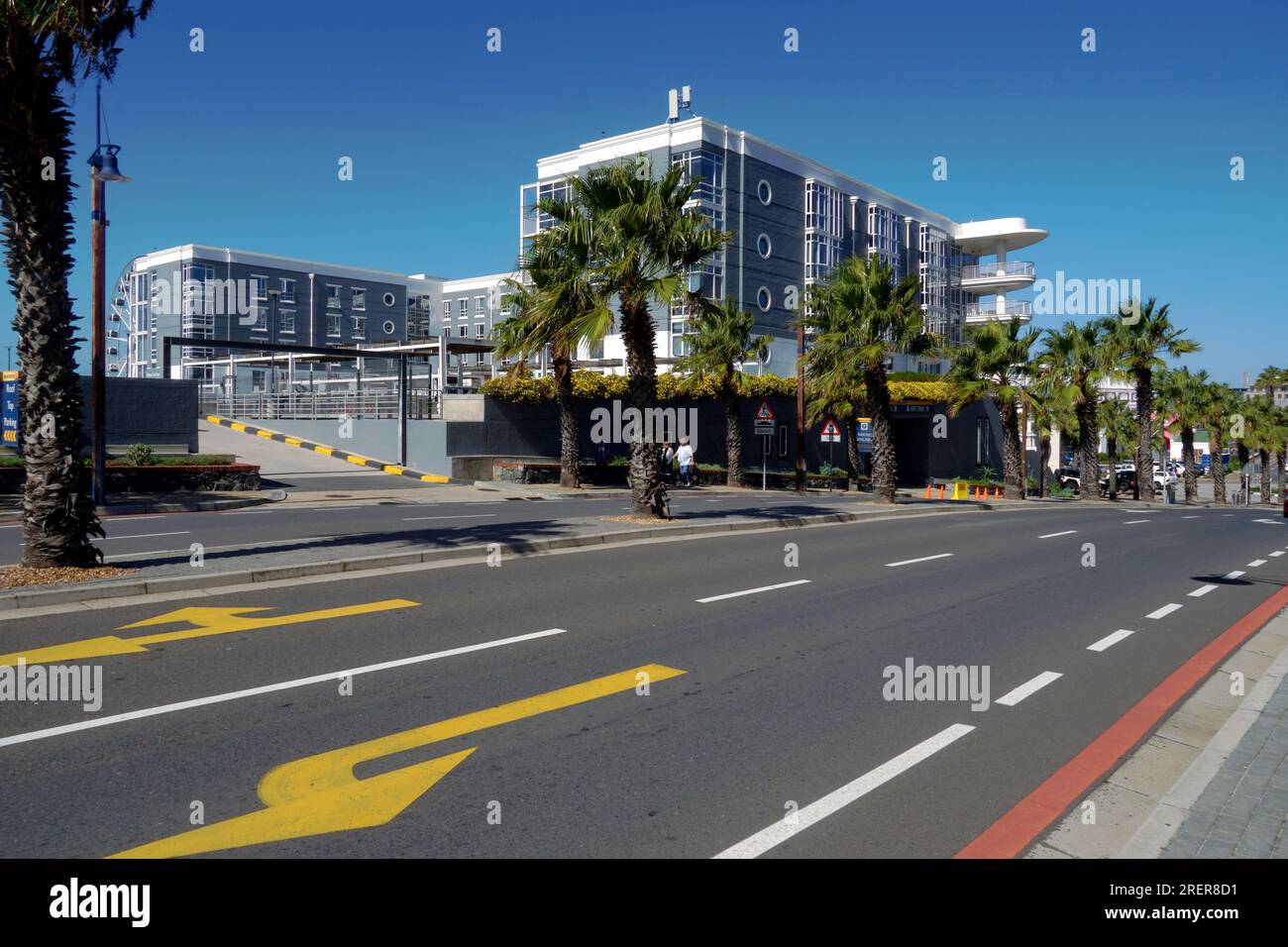 Main road with yellow marking as road sign passing near Waterfront ...