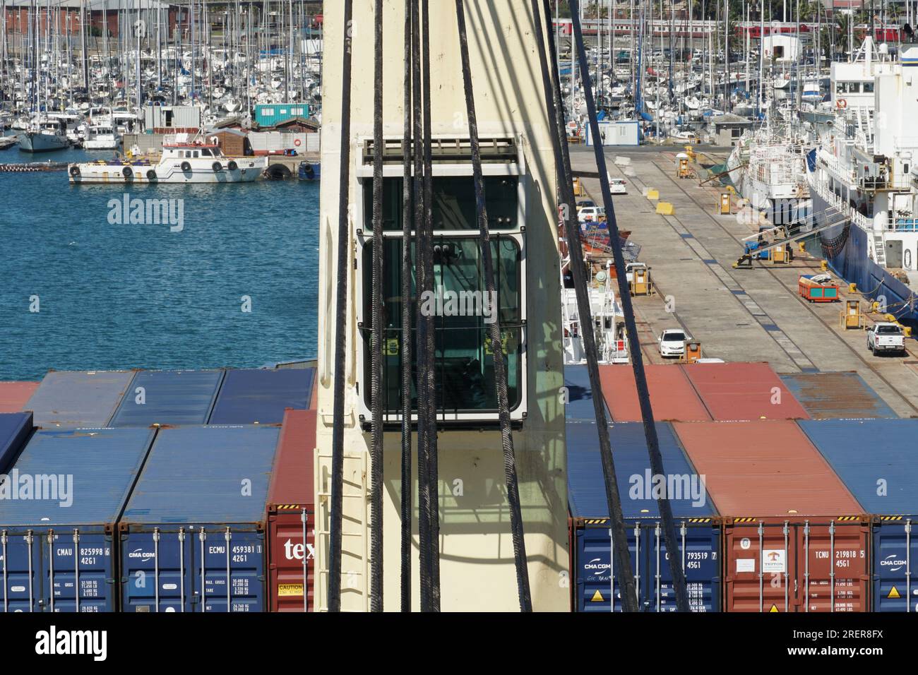 Direct view on cabin of ship crane behind steel greased wire of loaded ...