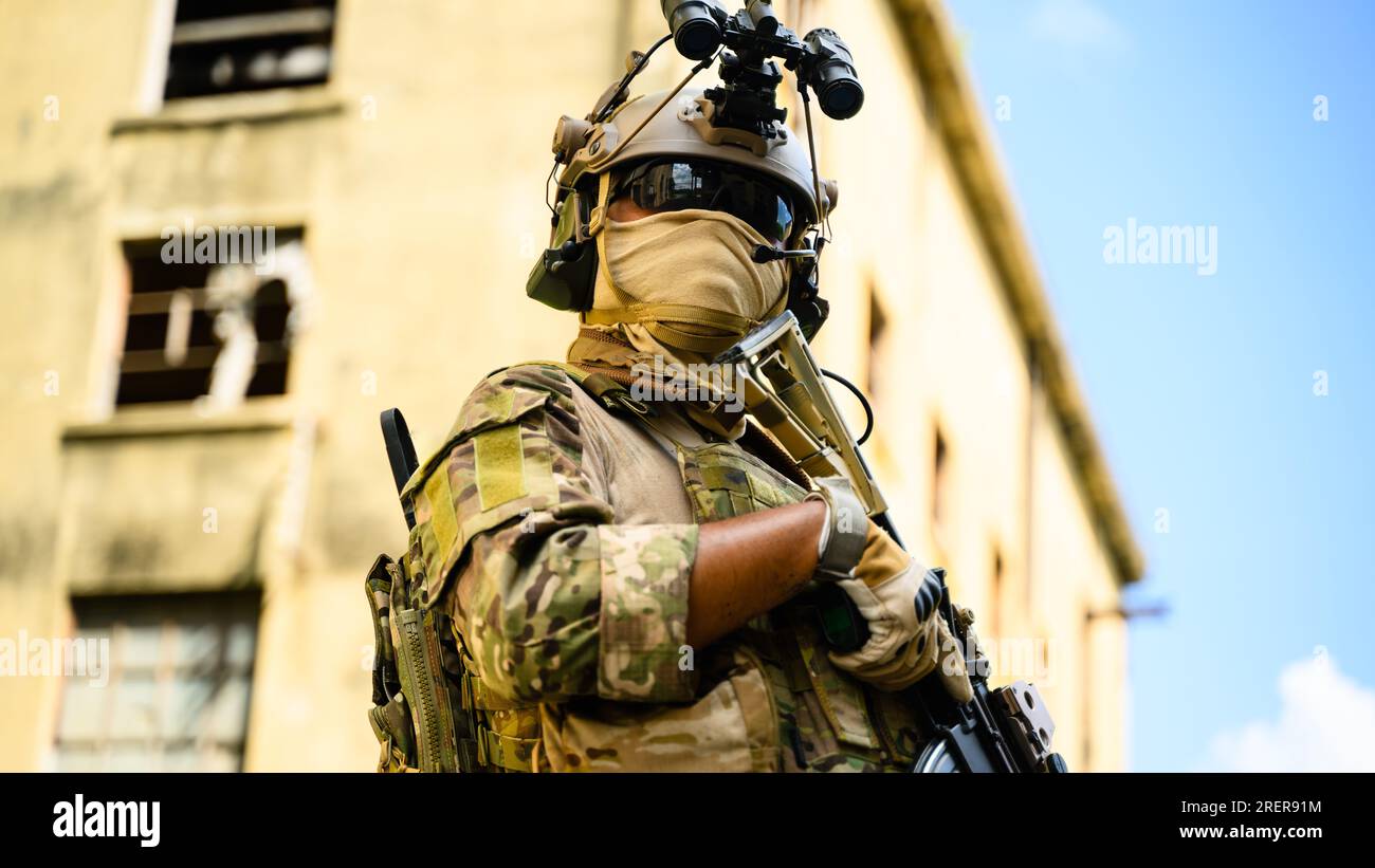 Expert team of soldiers with weapons attacking enemy during military ...