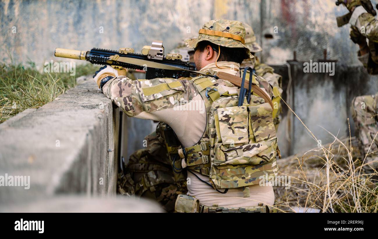 Smart teamwork of soldiers running forward and attacking enemy during ...