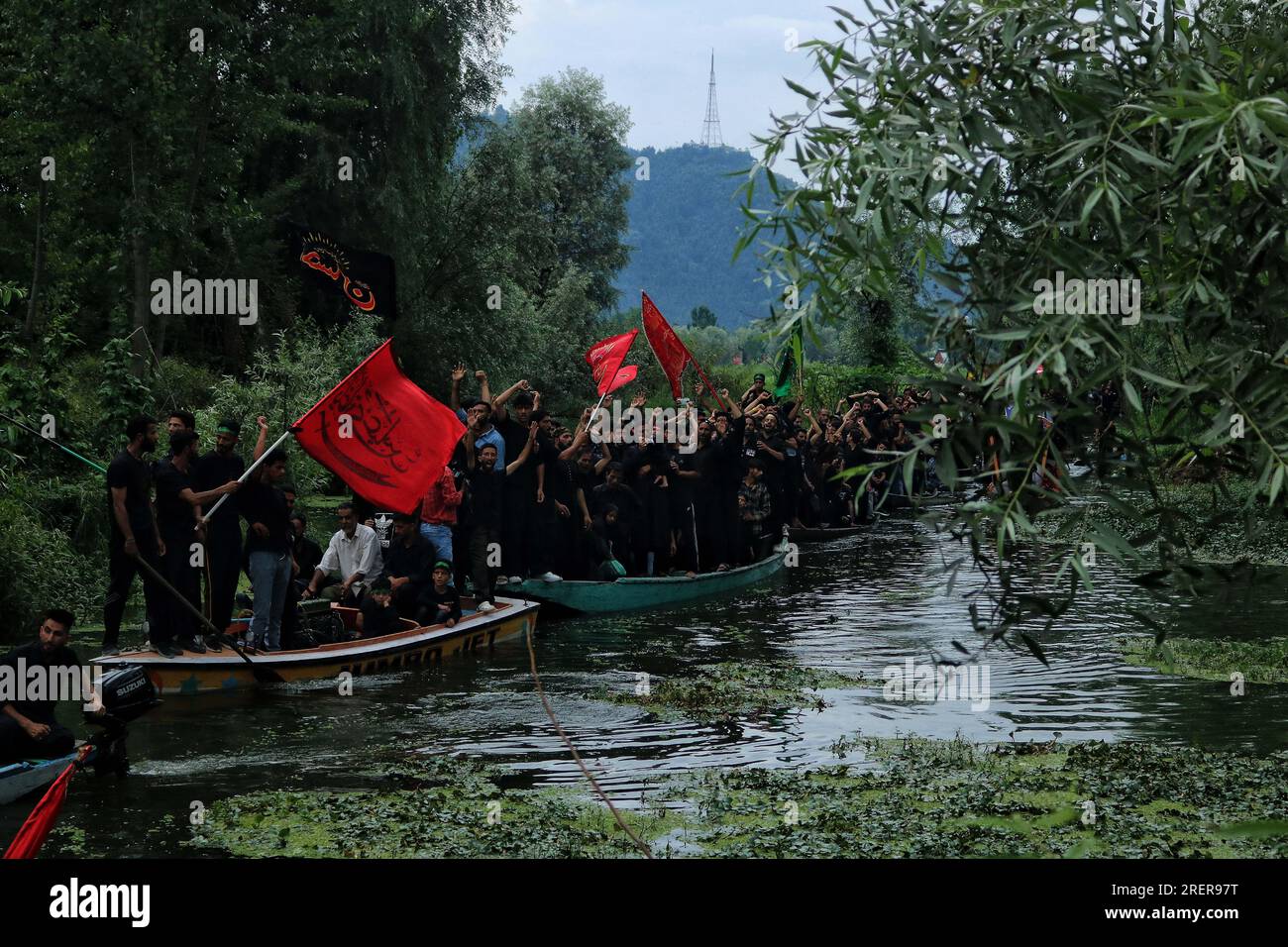Srinagar Kashmir, India. 28th July, 2023. Shiite Muslim mourners on boats participate in a ...