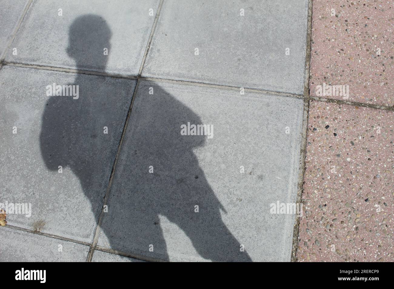 A photo of a boy's shadow on a pavement Stock Photo - Alamy