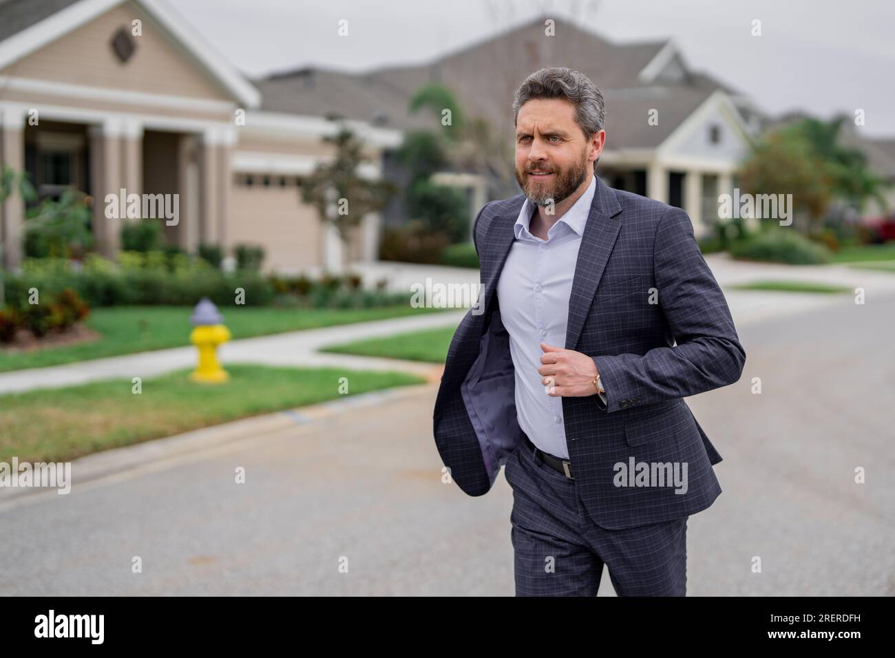 Business man run near house in american neighborhood. Businessman run ...