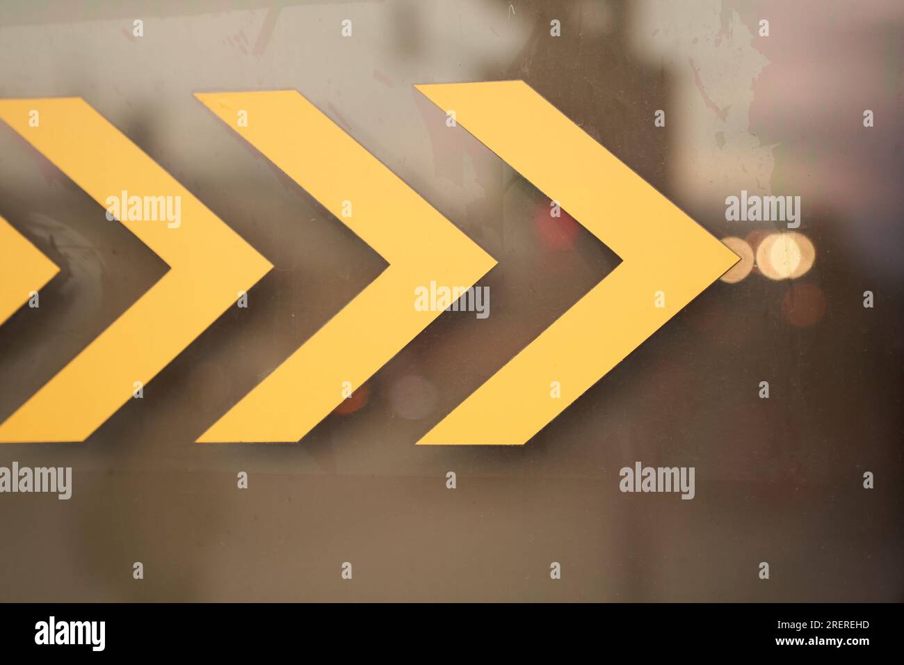 Exit turn sign with arrow sign on transparent glass door. Close-up ...