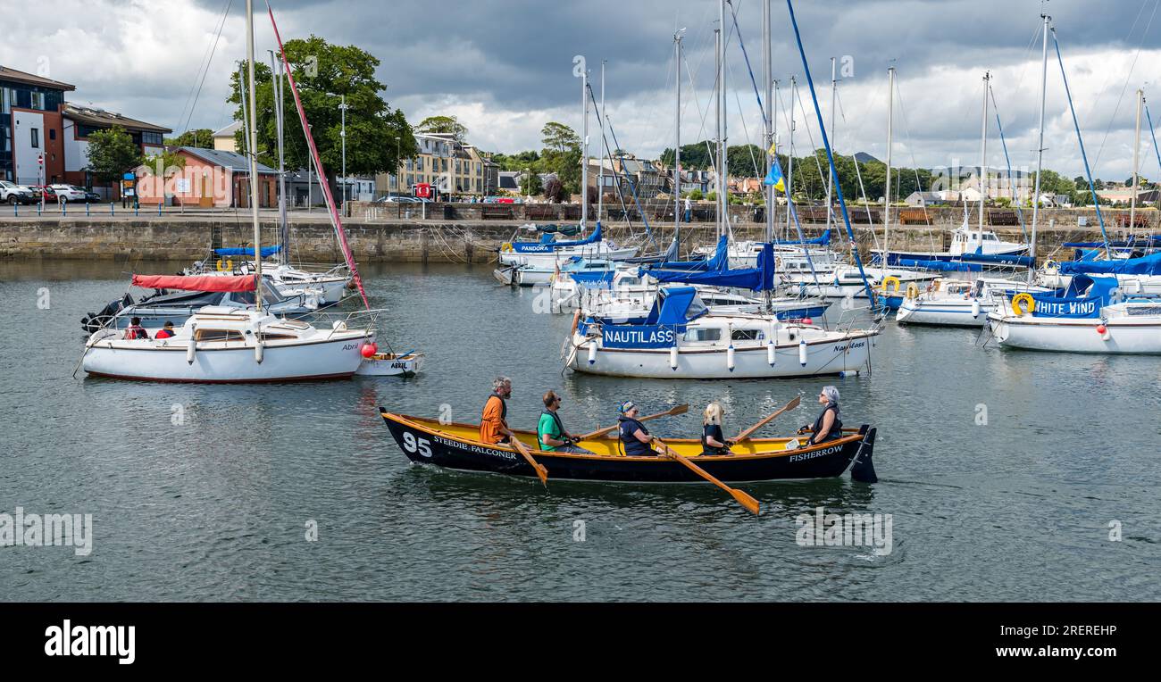 People in St Ayles rowing skiff and yachts and boats, Fisherrow Harbour ...
