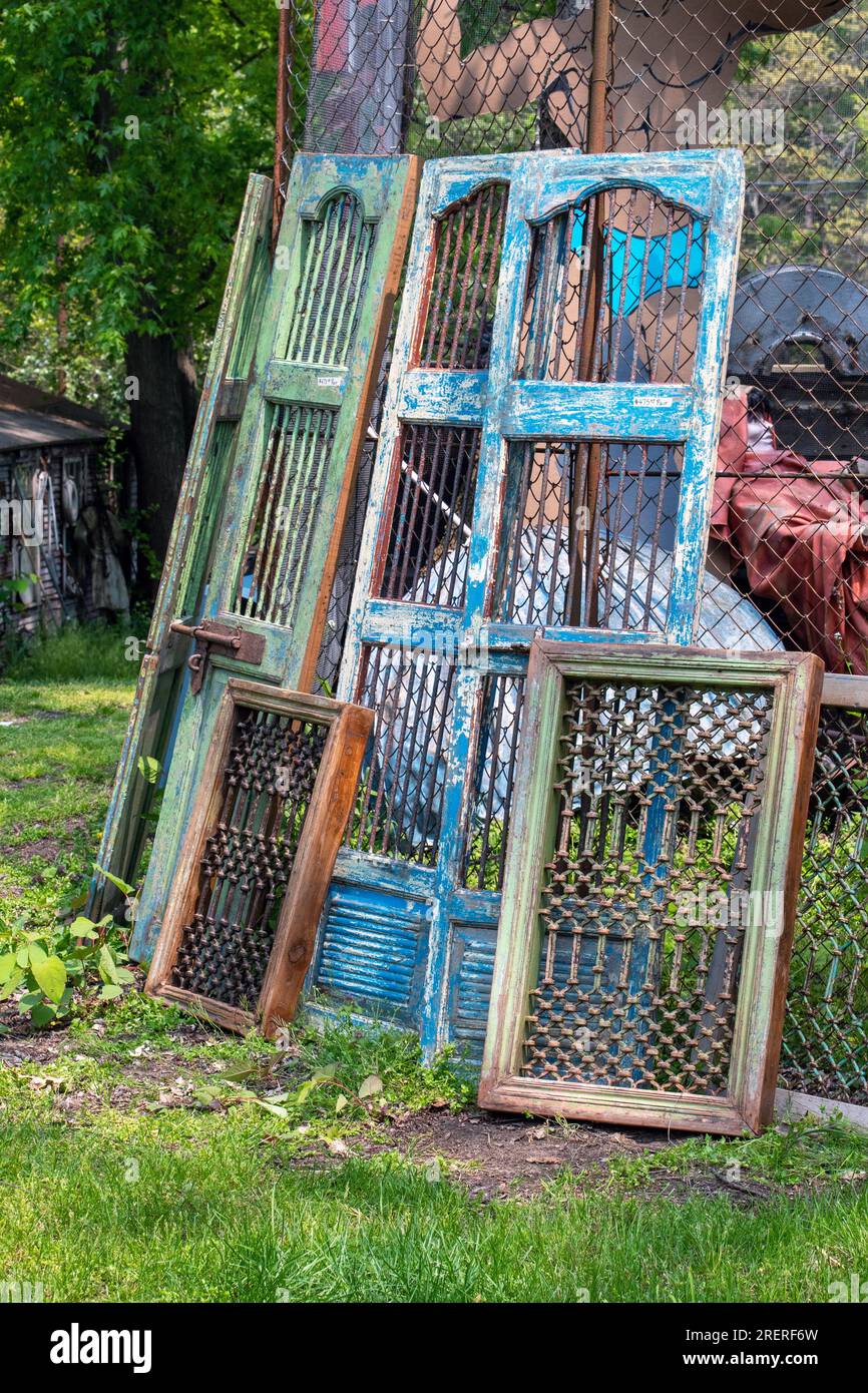 Ornate door and windows are being recycled at a outdoor salvage sale ...