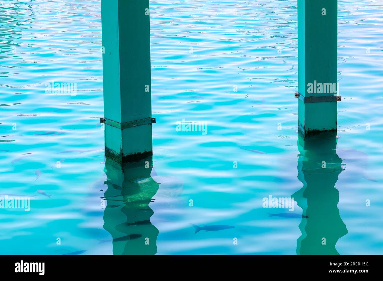 Reflection of a pier pillars in the water. Blue water background Stock ...