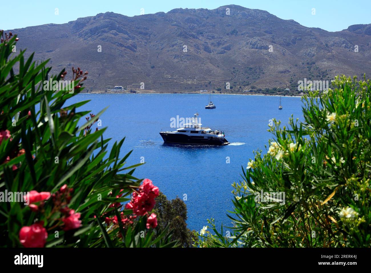 Boat heading out to sea, leaving Livadia harbour, Tilos, Dodecanese ...