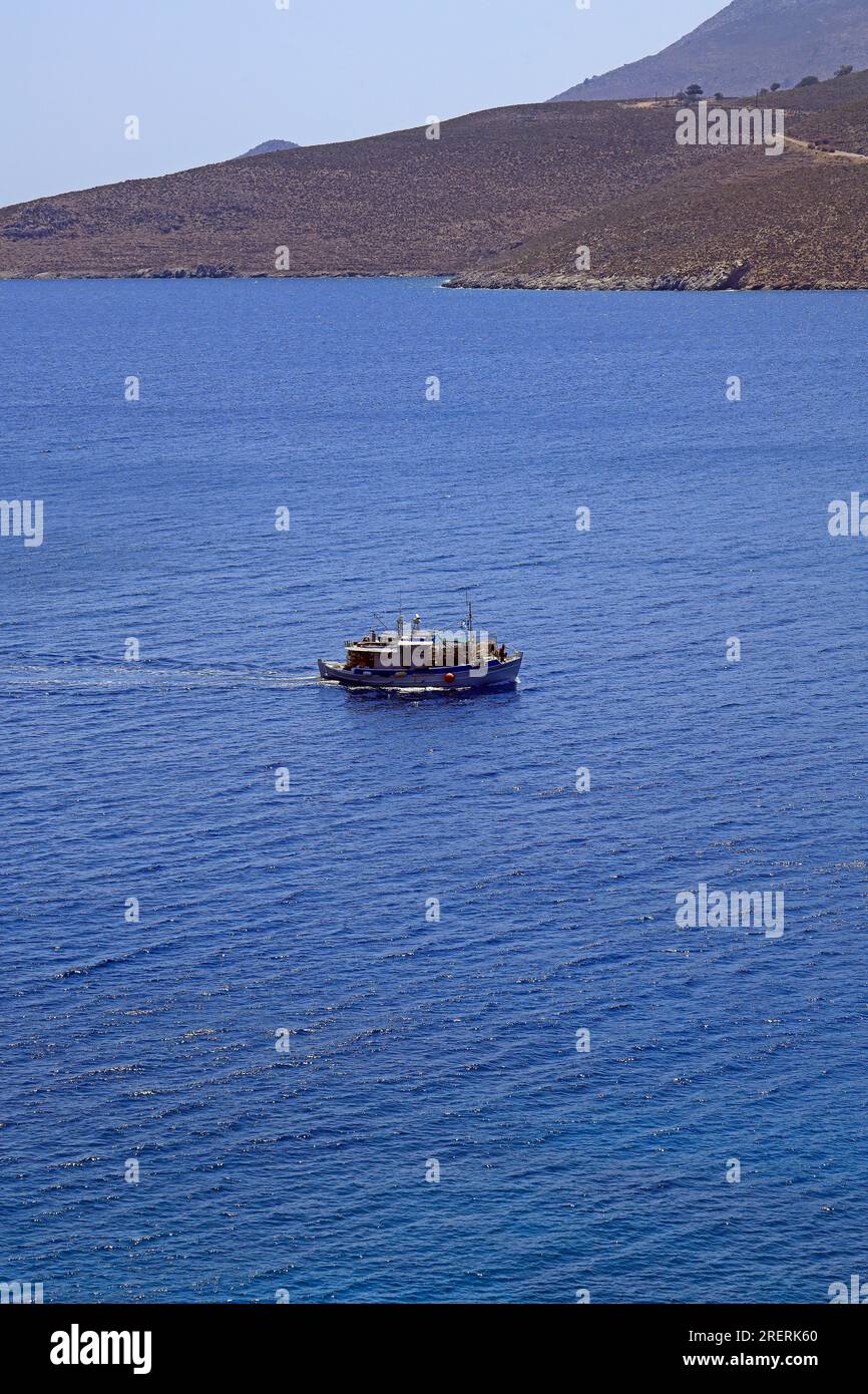 Local fishing boat coming back into Livadia harbour, Tilos island ...
