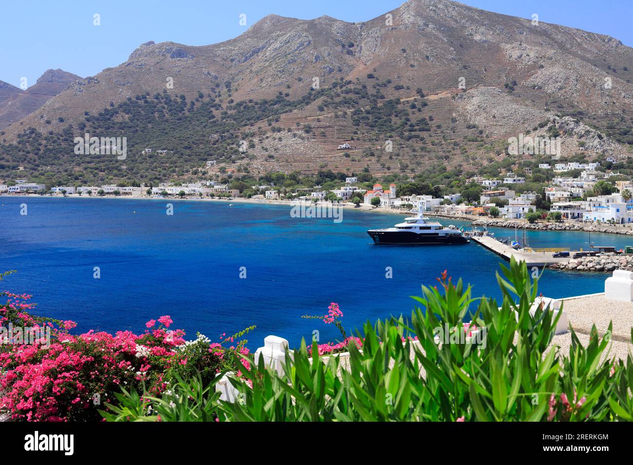 Boat heading out to sea, leaving Livadia harbour, Tilos, Dodecanese ...