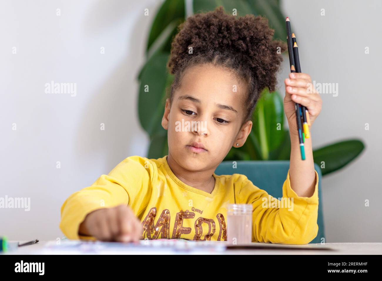 Beautiful girl playing on her own, developing artistic skills ...