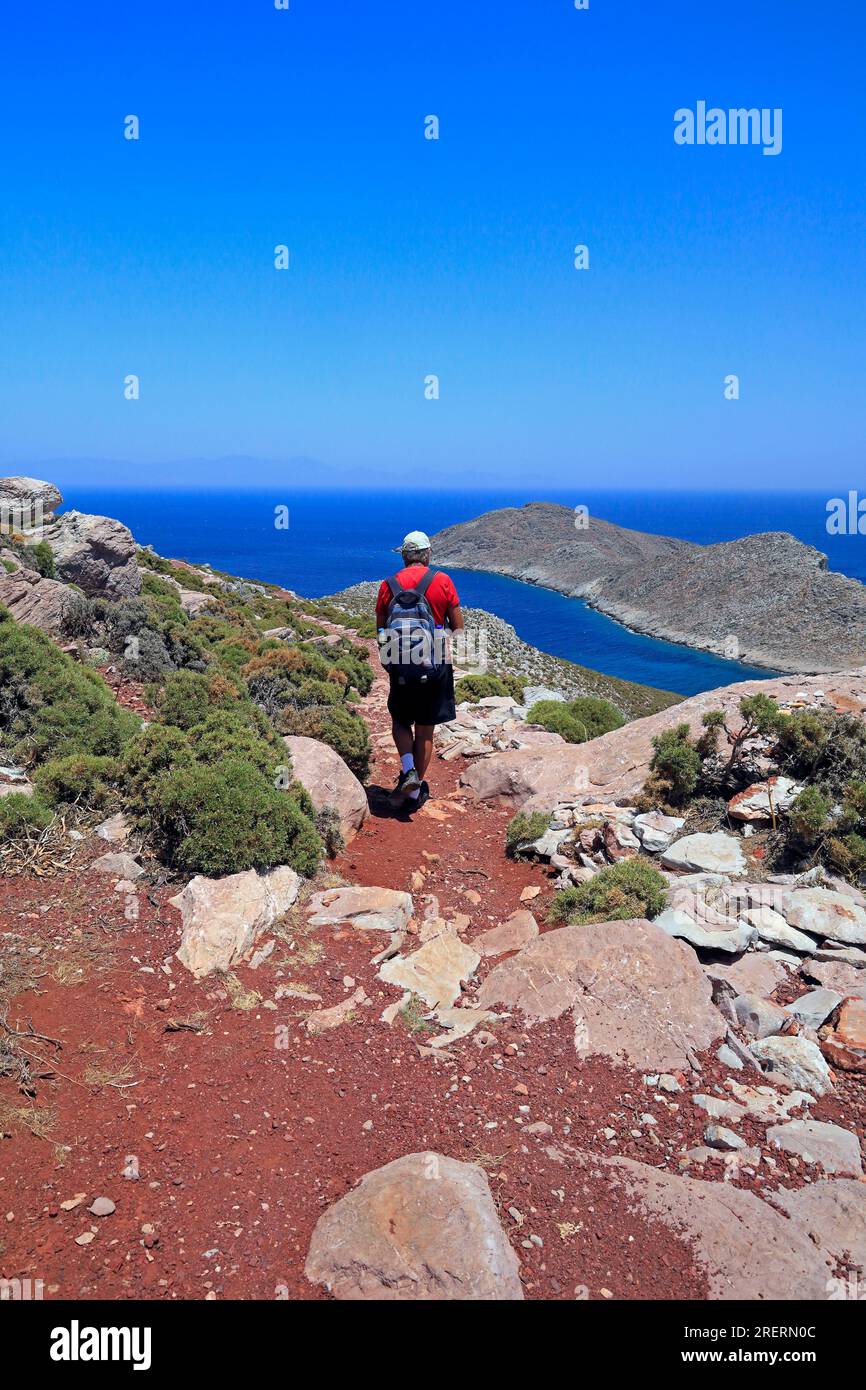 Walker on the path from Livadia to Lethra beach along the rocky ...