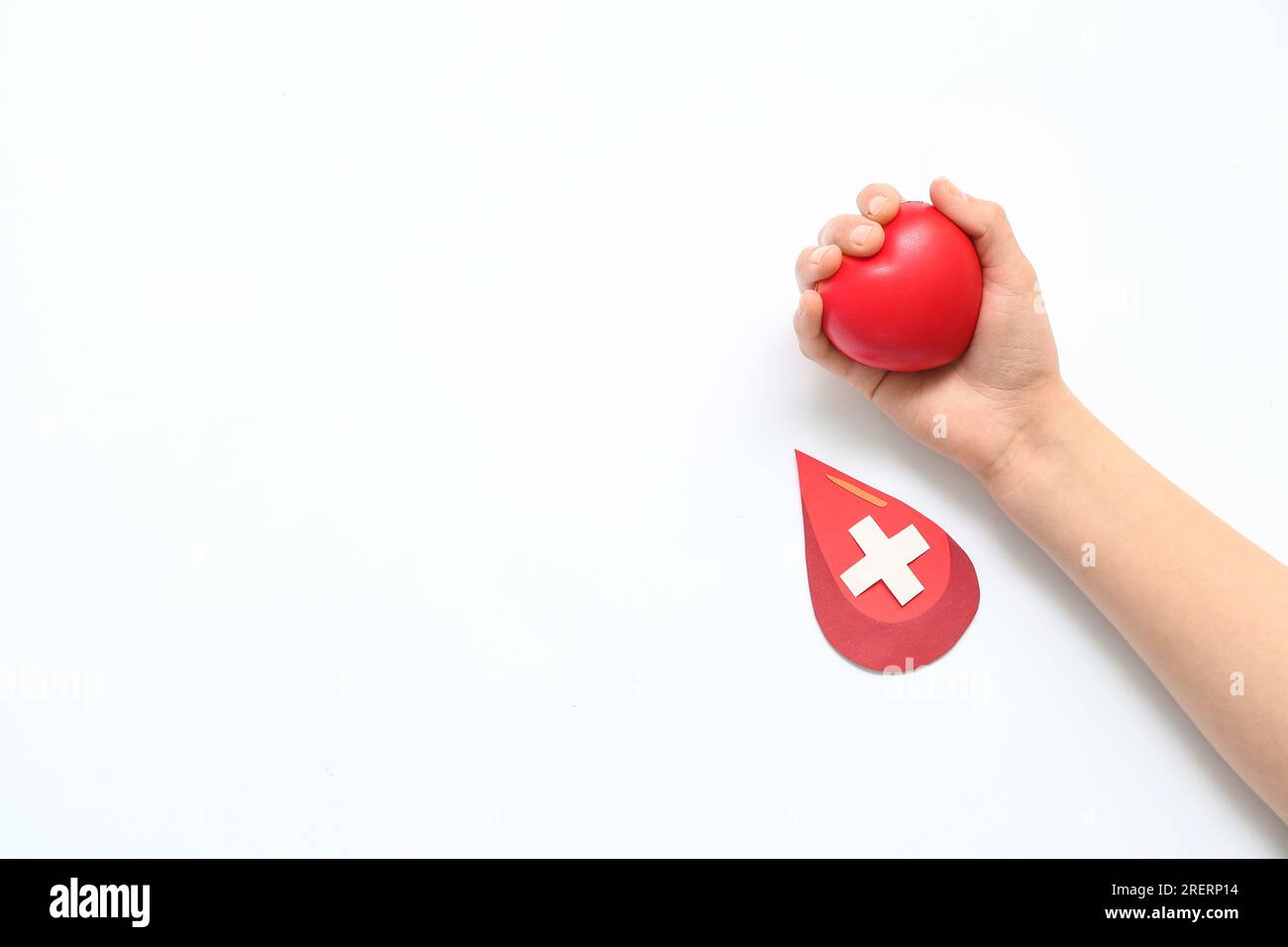 Woman holding grip ball and paper blood drop with cross on white ...