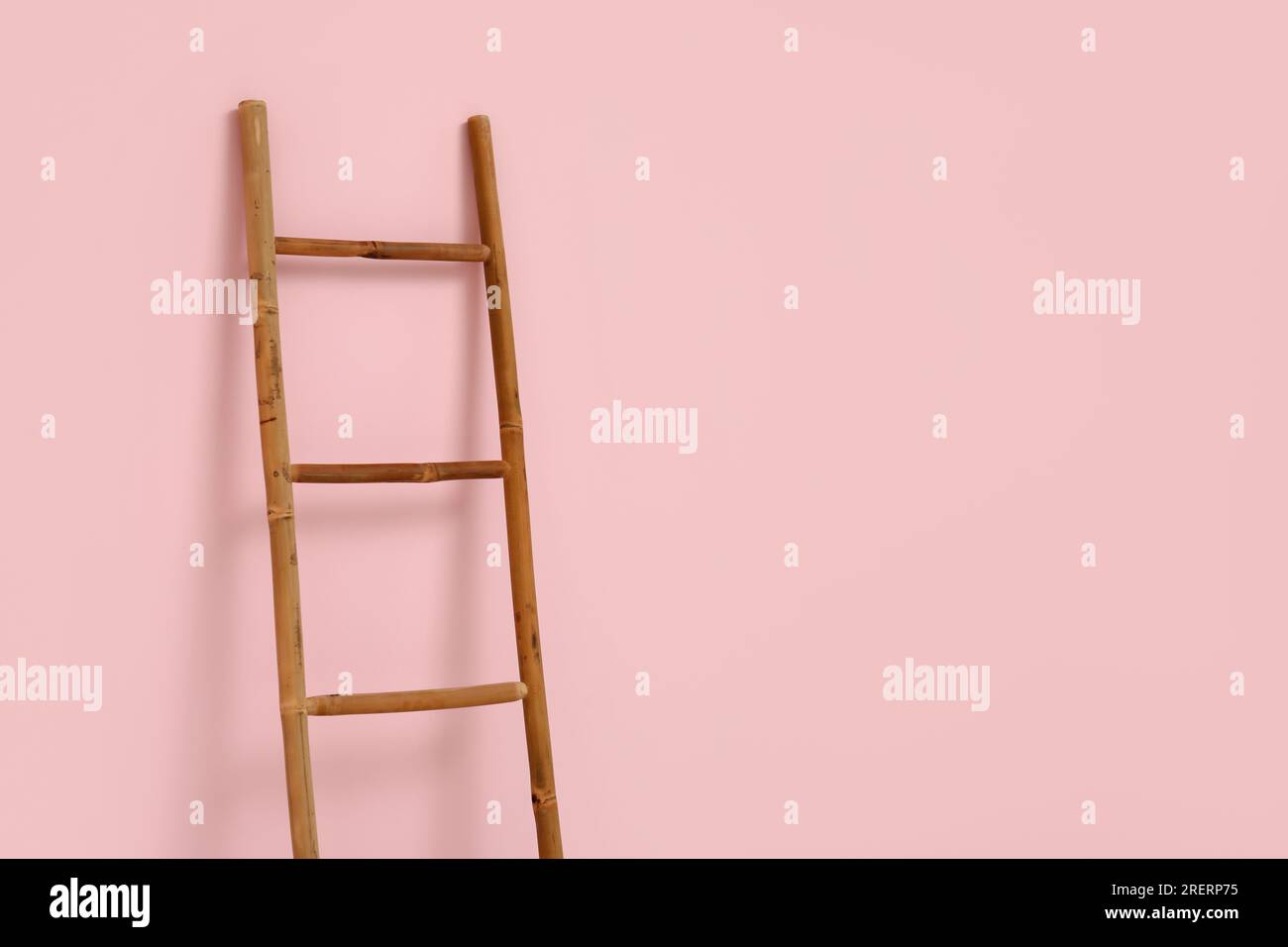 Wooden ladder near pink wall in room Stock Photo - Alamy